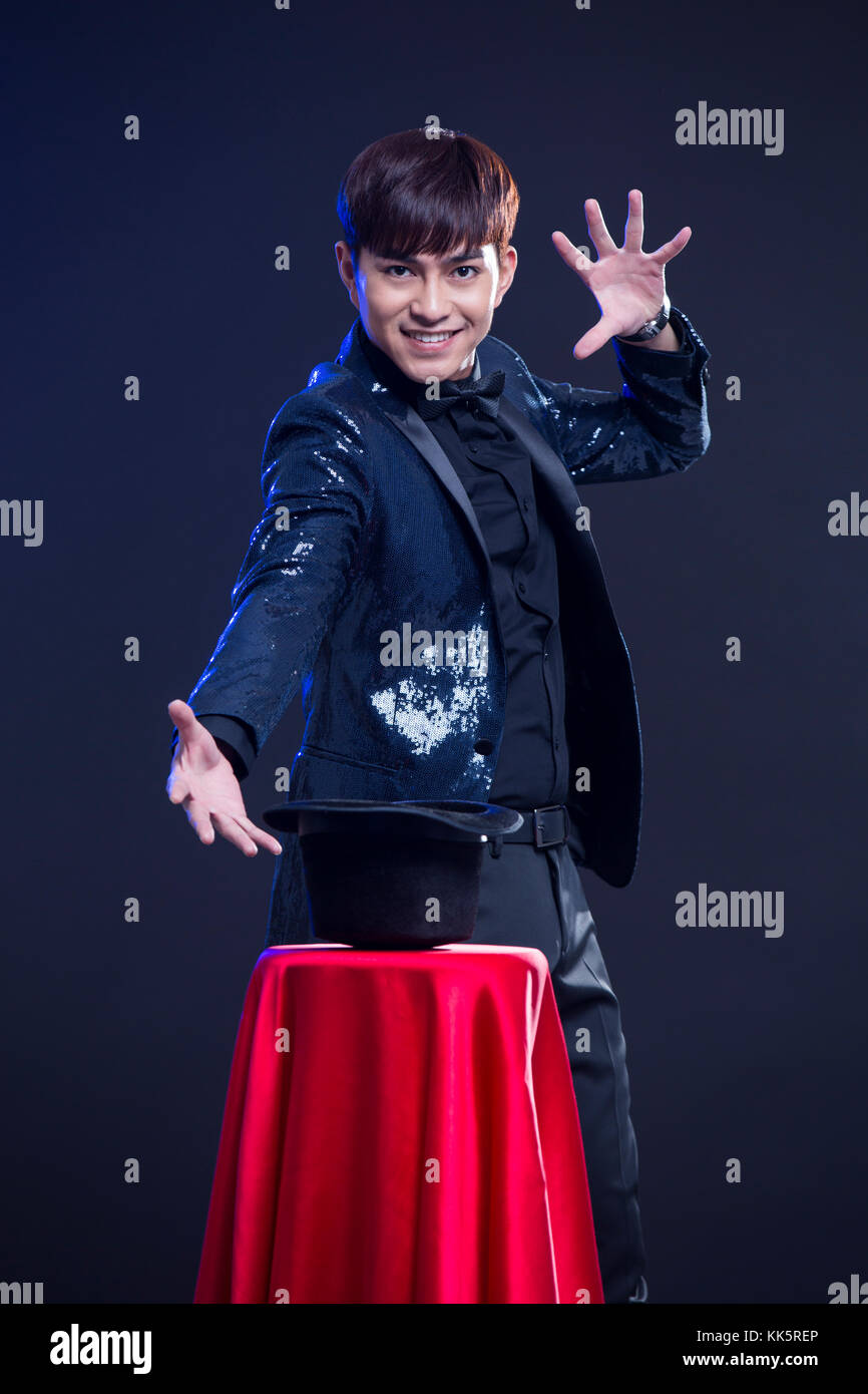 Young Chinese magician performing magic trick Stock Photo - Alamy
