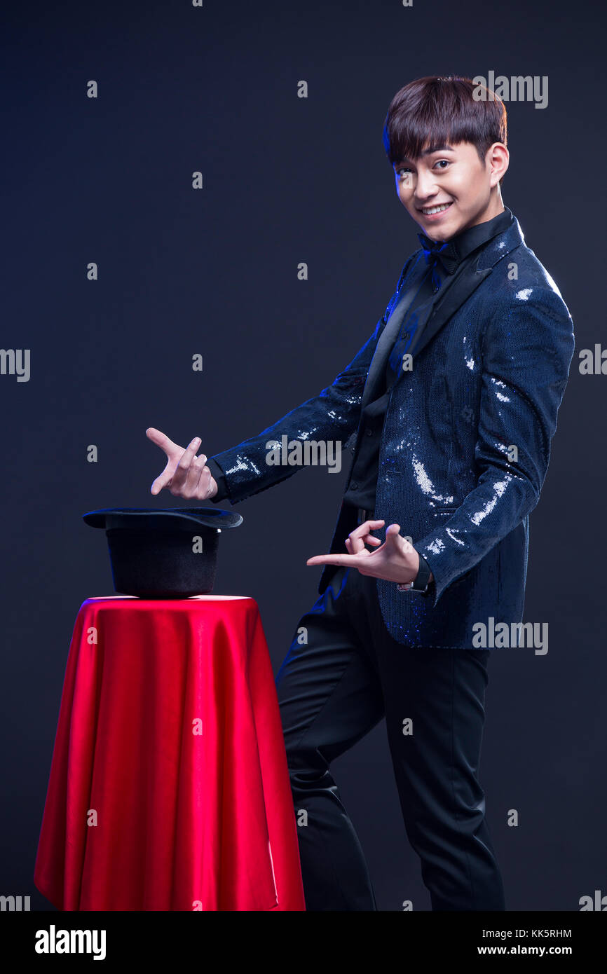 Young Chinese magician performing magic trick Stock Photo - Alamy