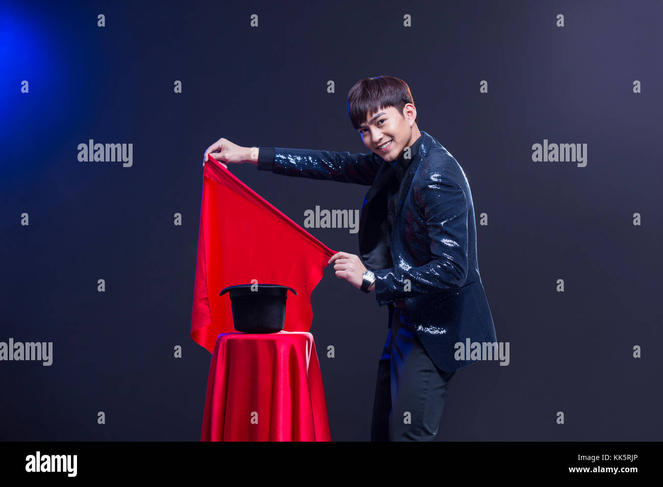 Young Chinese magician performing magic trick Stock Photo - Alamy