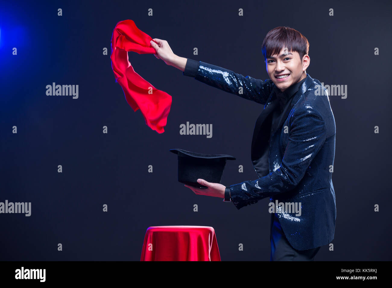 Young Chinese magician performing magic trick Stock Photo - Alamy