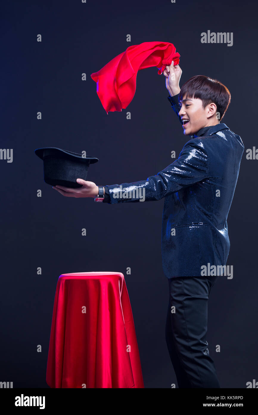 Young Chinese magician performing magic trick Stock Photo - Alamy