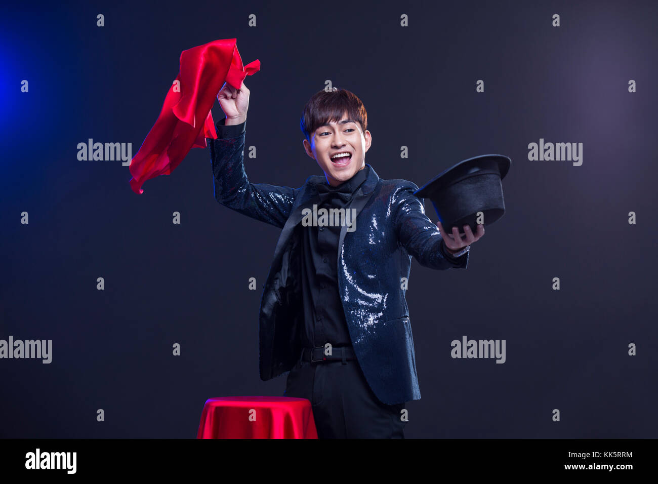 Young Chinese magician performing magic trick Stock Photo - Alamy