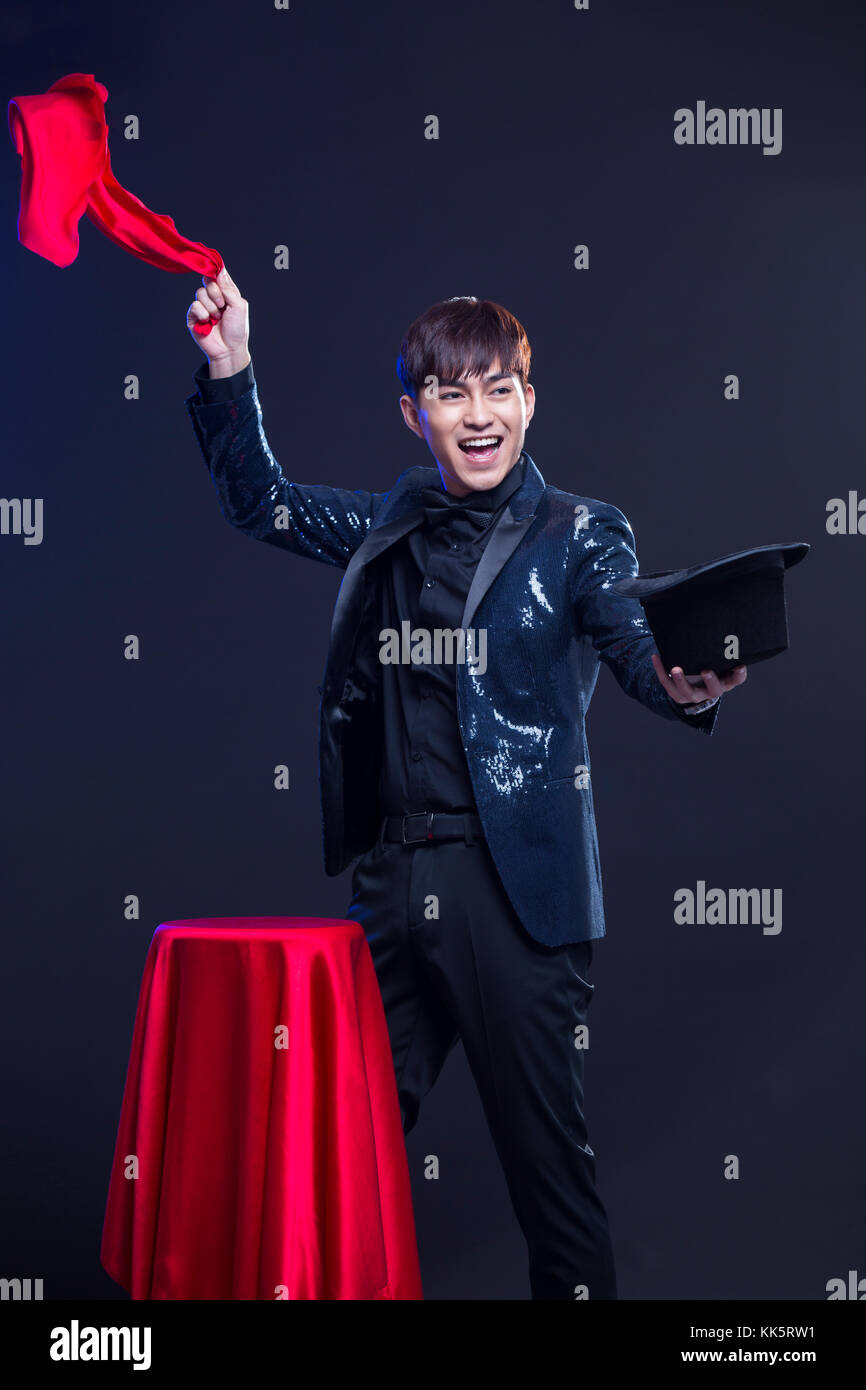 Young Chinese magician performing magic trick Stock Photo - Alamy