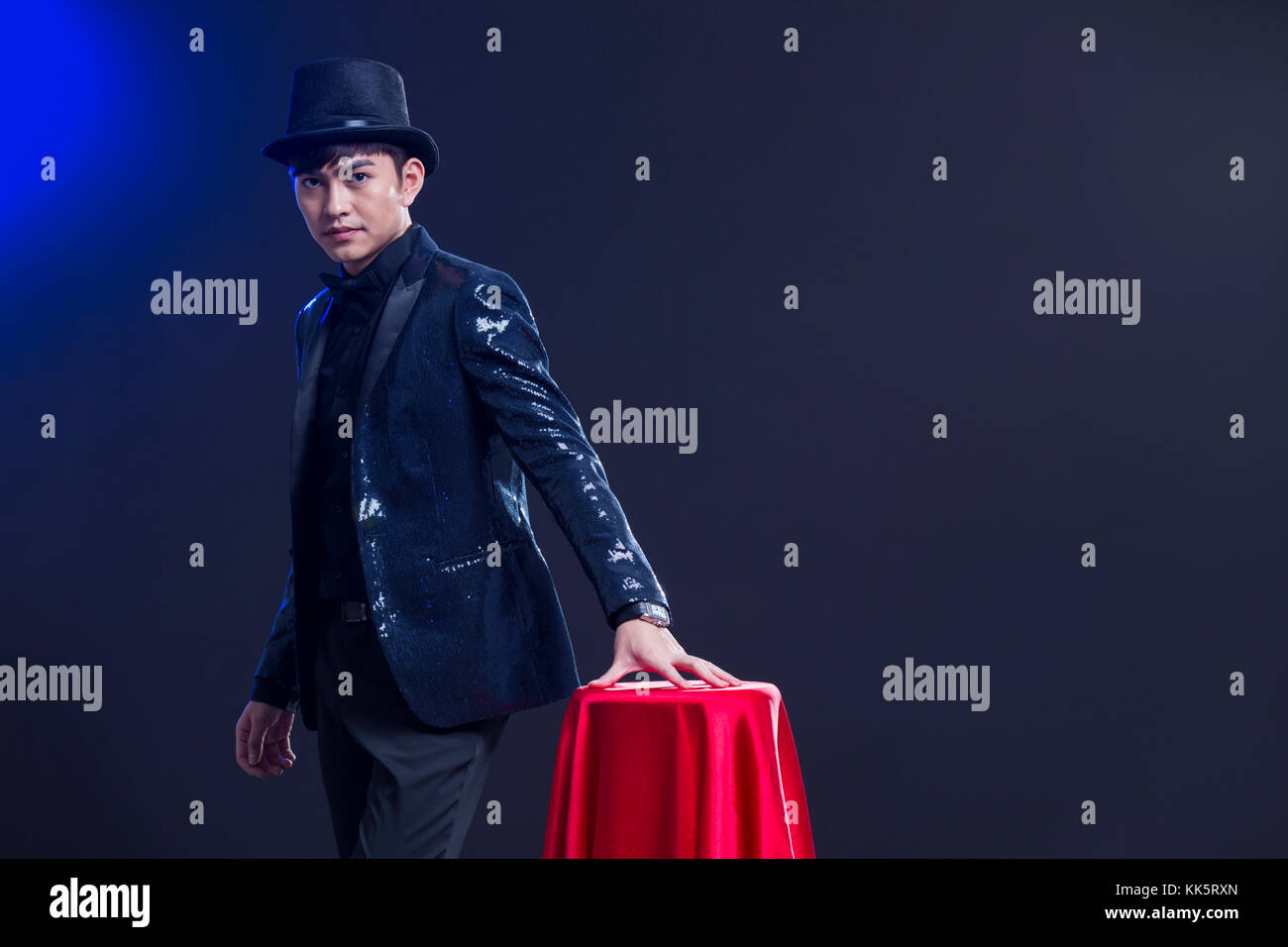 Young Chinese magician performing magic trick Stock Photo - Alamy