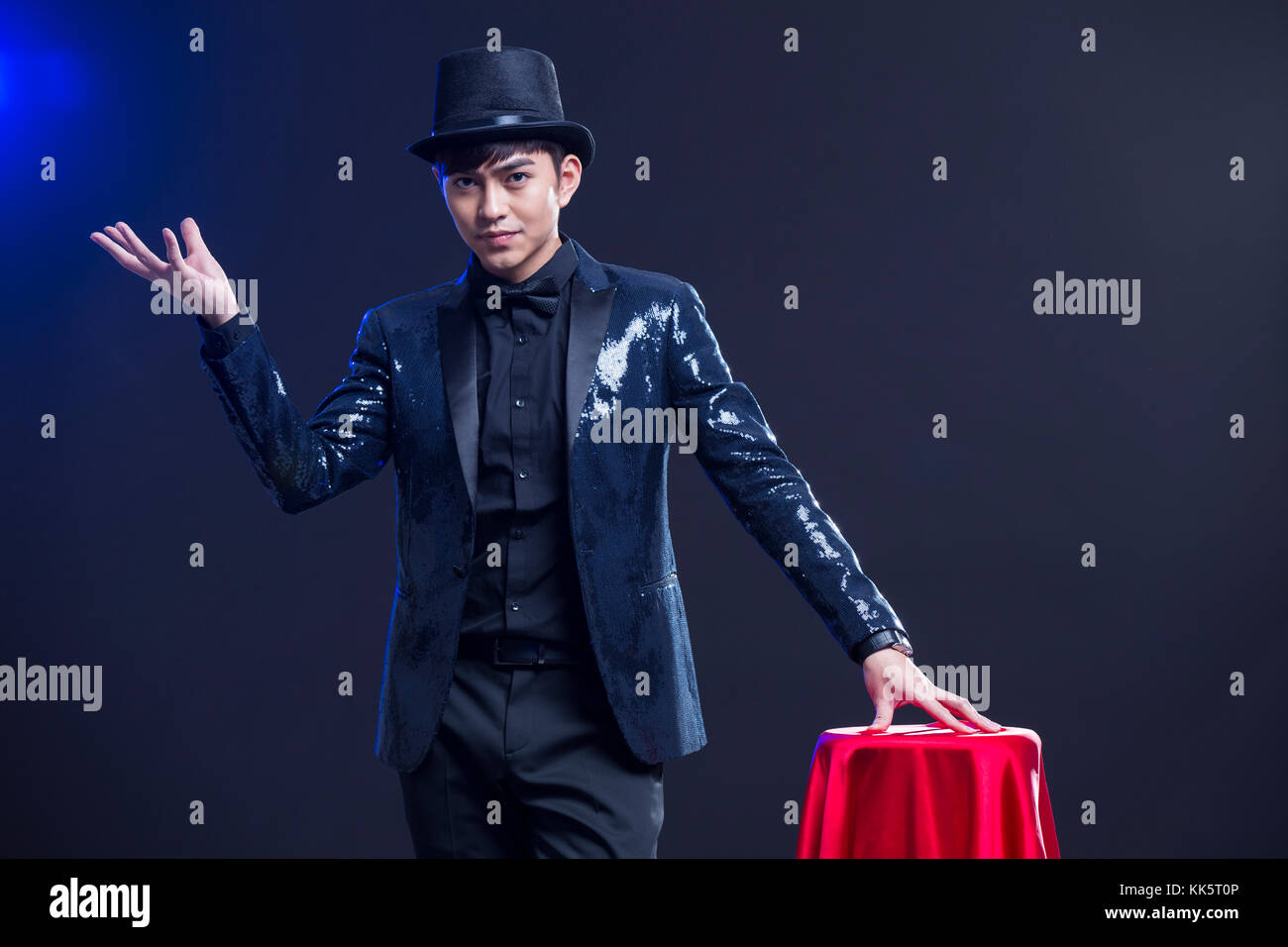 Young Chinese magician performing magic trick Stock Photo - Alamy