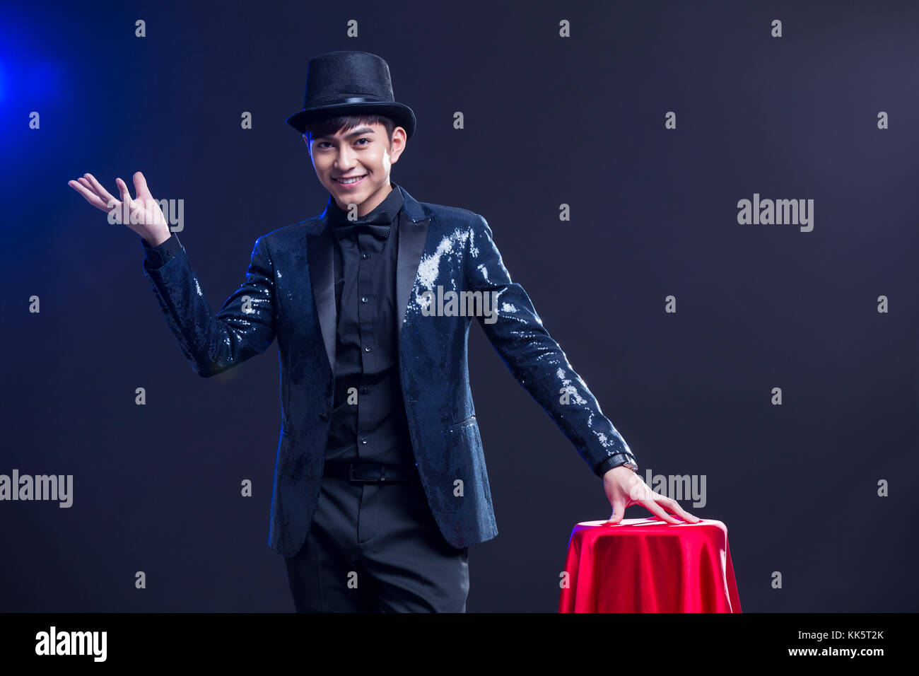 Young Chinese magician performing magic trick Stock Photo - Alamy