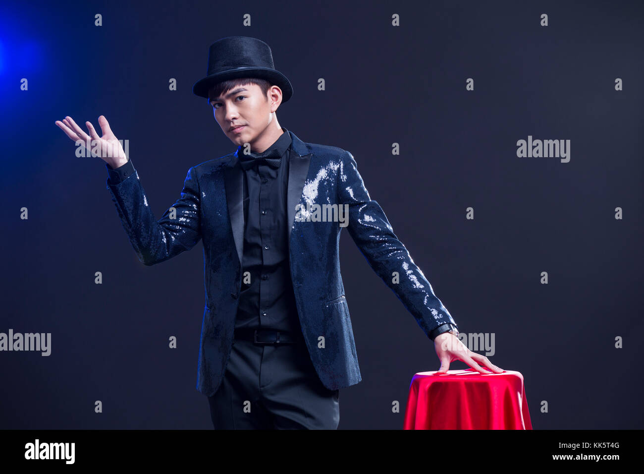 Young Chinese magician performing magic trick Stock Photo - Alamy