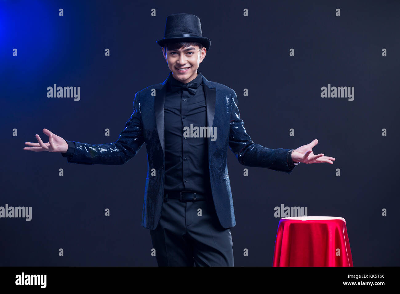 Young Chinese magician performing magic trick Stock Photo - Alamy