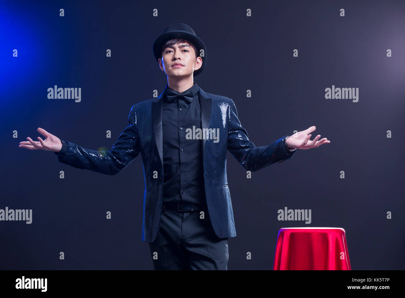 Young Chinese magician performing magic trick Stock Photo - Alamy