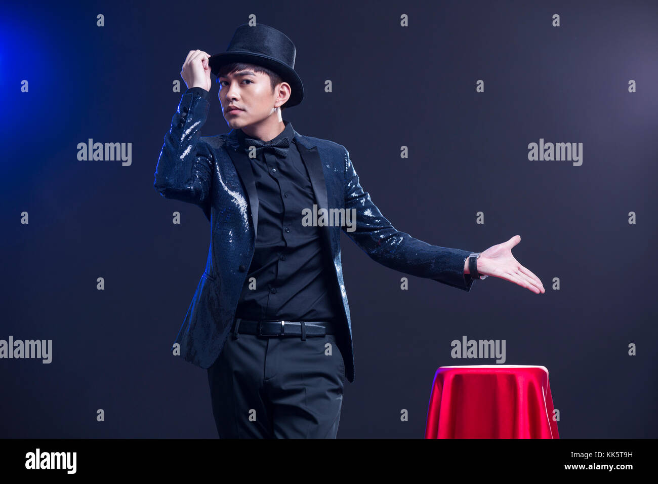 Young Chinese magician performing magic trick Stock Photo - Alamy