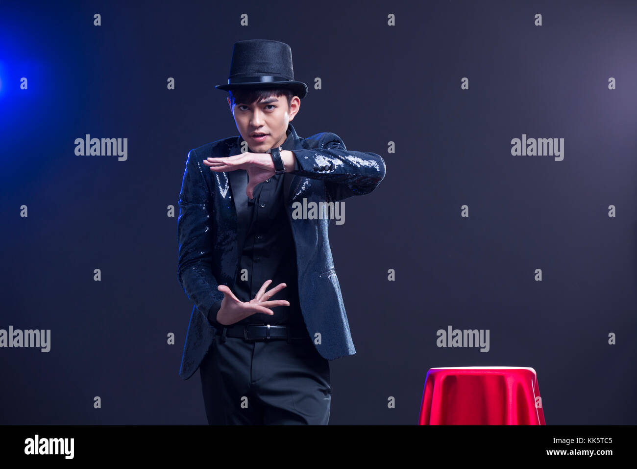Young Chinese magician performing magic trick Stock Photo - Alamy