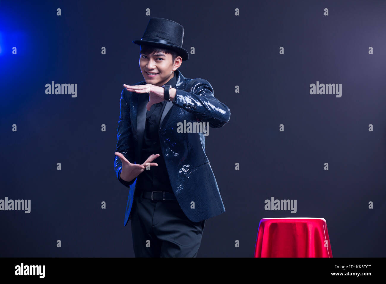 Young Chinese magician performing magic trick Stock Photo - Alamy