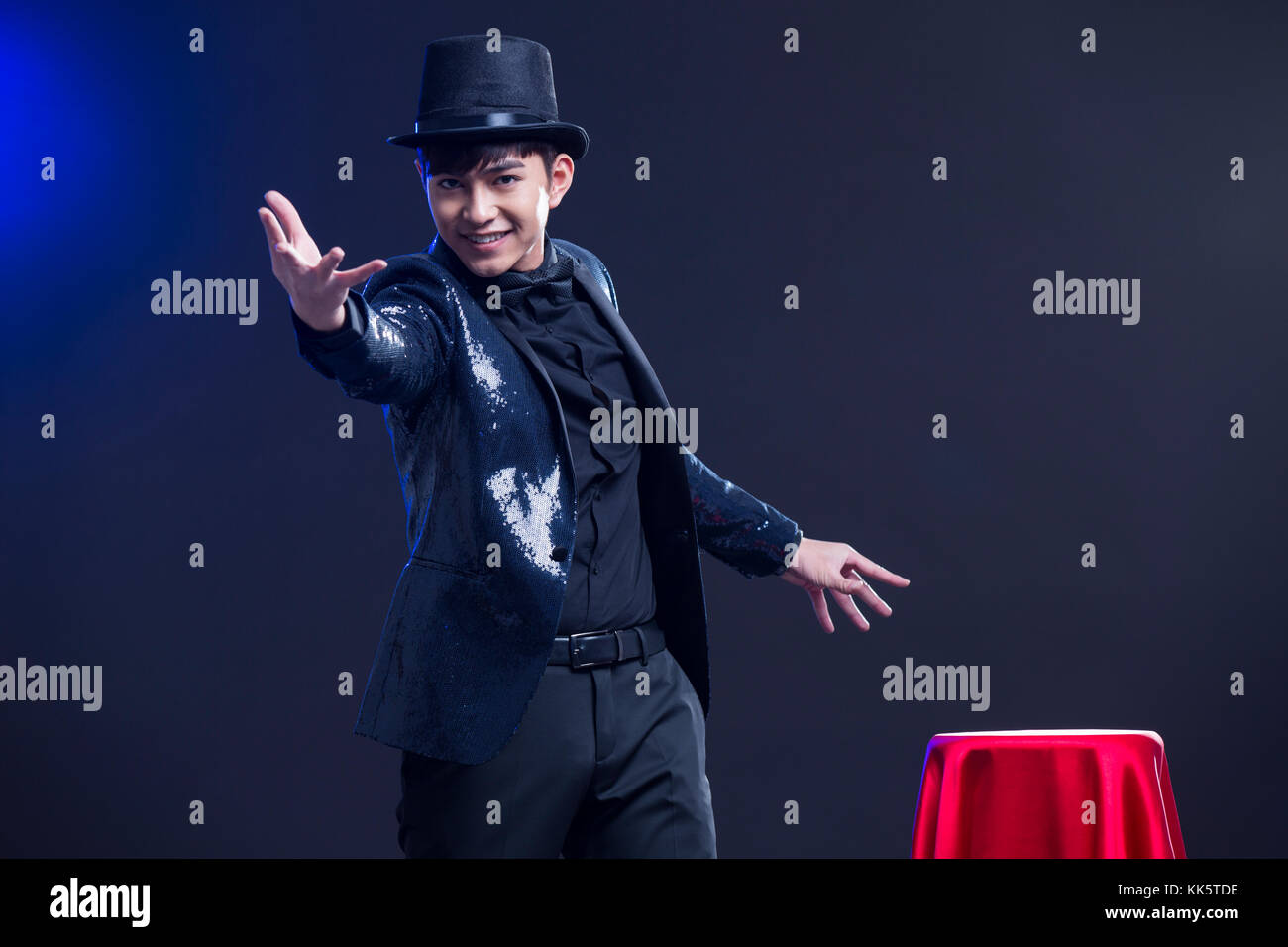 Young Chinese magician performing magic trick Stock Photo - Alamy