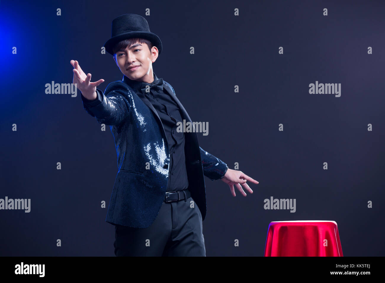 Young Chinese magician performing magic trick Stock Photo - Alamy