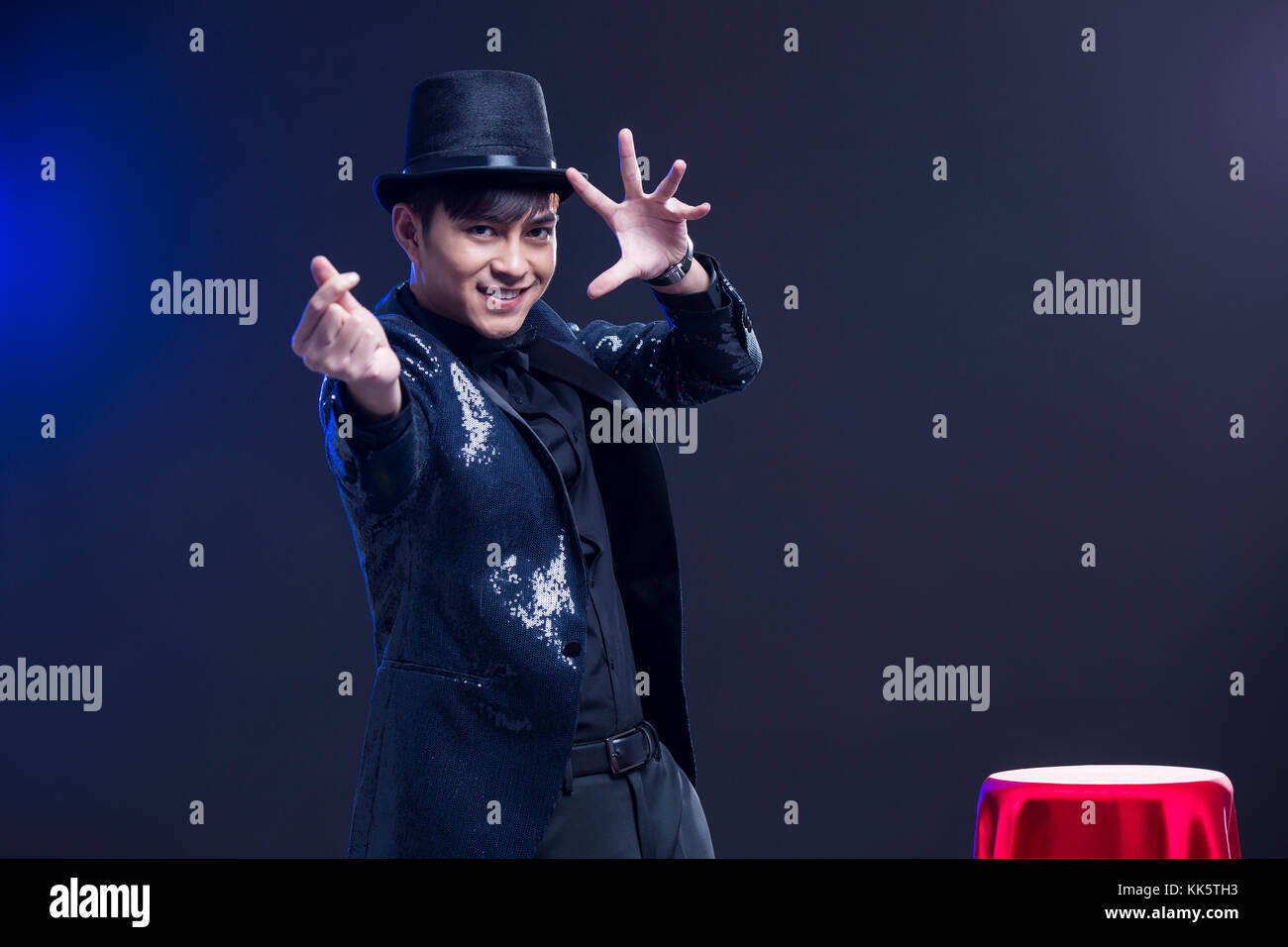 Young Chinese magician performing magic trick Stock Photo - Alamy