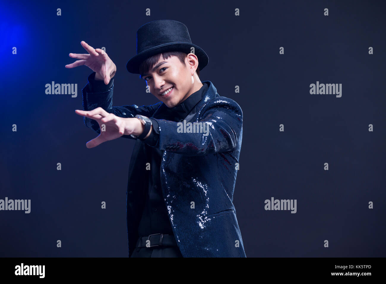 Young Chinese magician performing magic trick Stock Photo - Alamy
