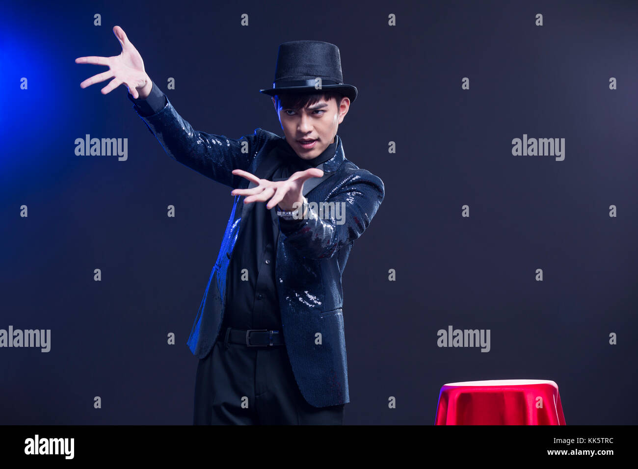 Young Chinese magician performing magic trick Stock Photo - Alamy