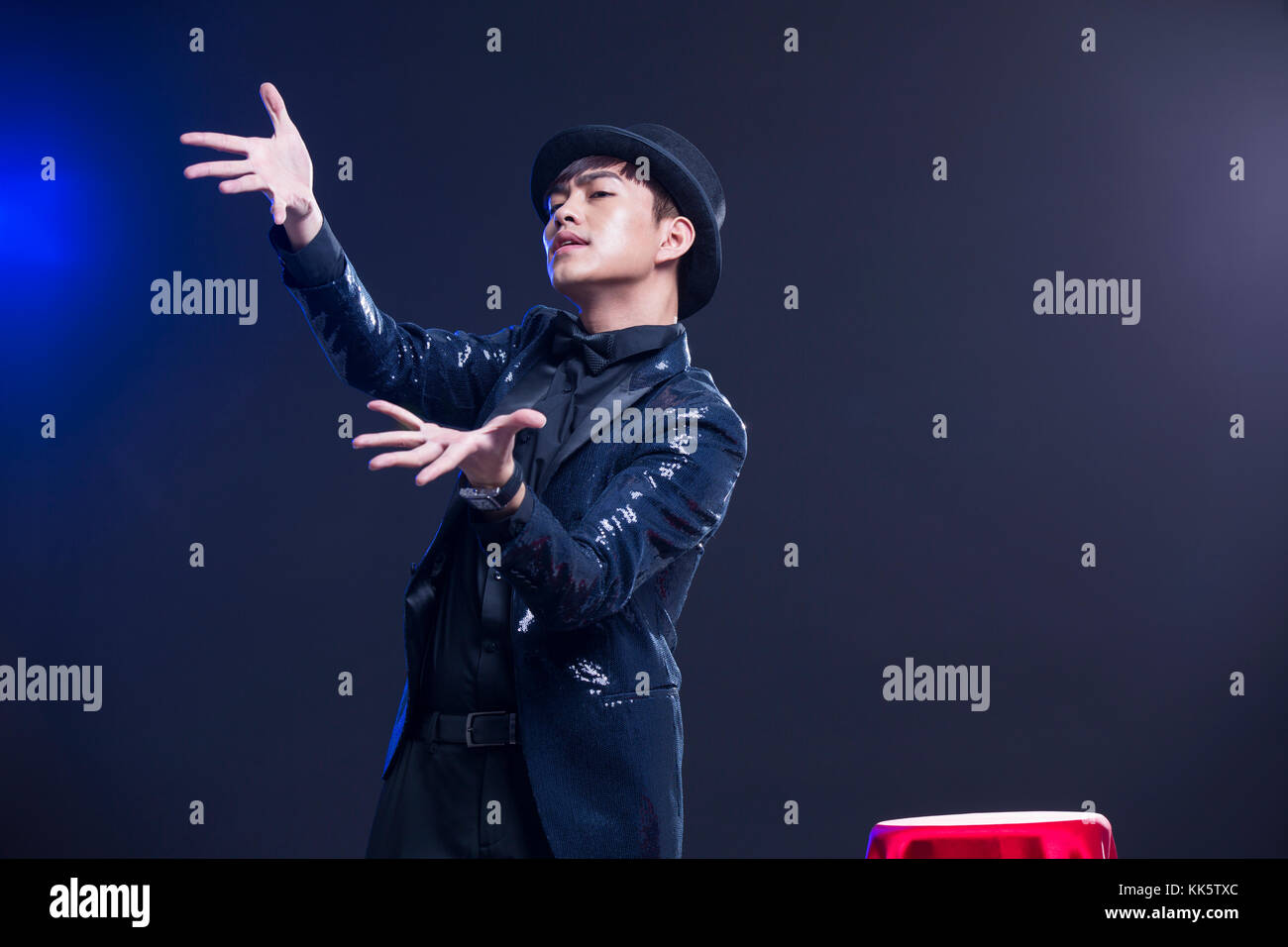 Young Chinese magician performing magic trick Stock Photo - Alamy