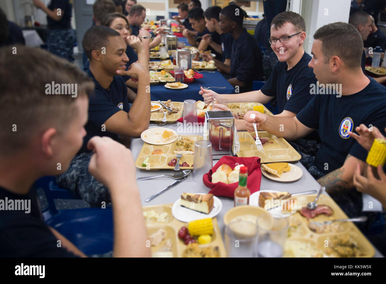 Sailors gather on the mess decks for Thanksgiving dinner aboard the ...