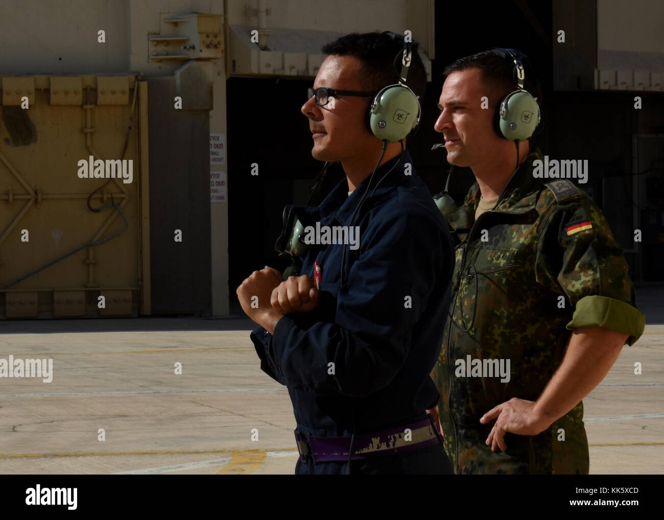 A German air force crew chief, right, shadows U.S. Air Force Airman 1st ...
