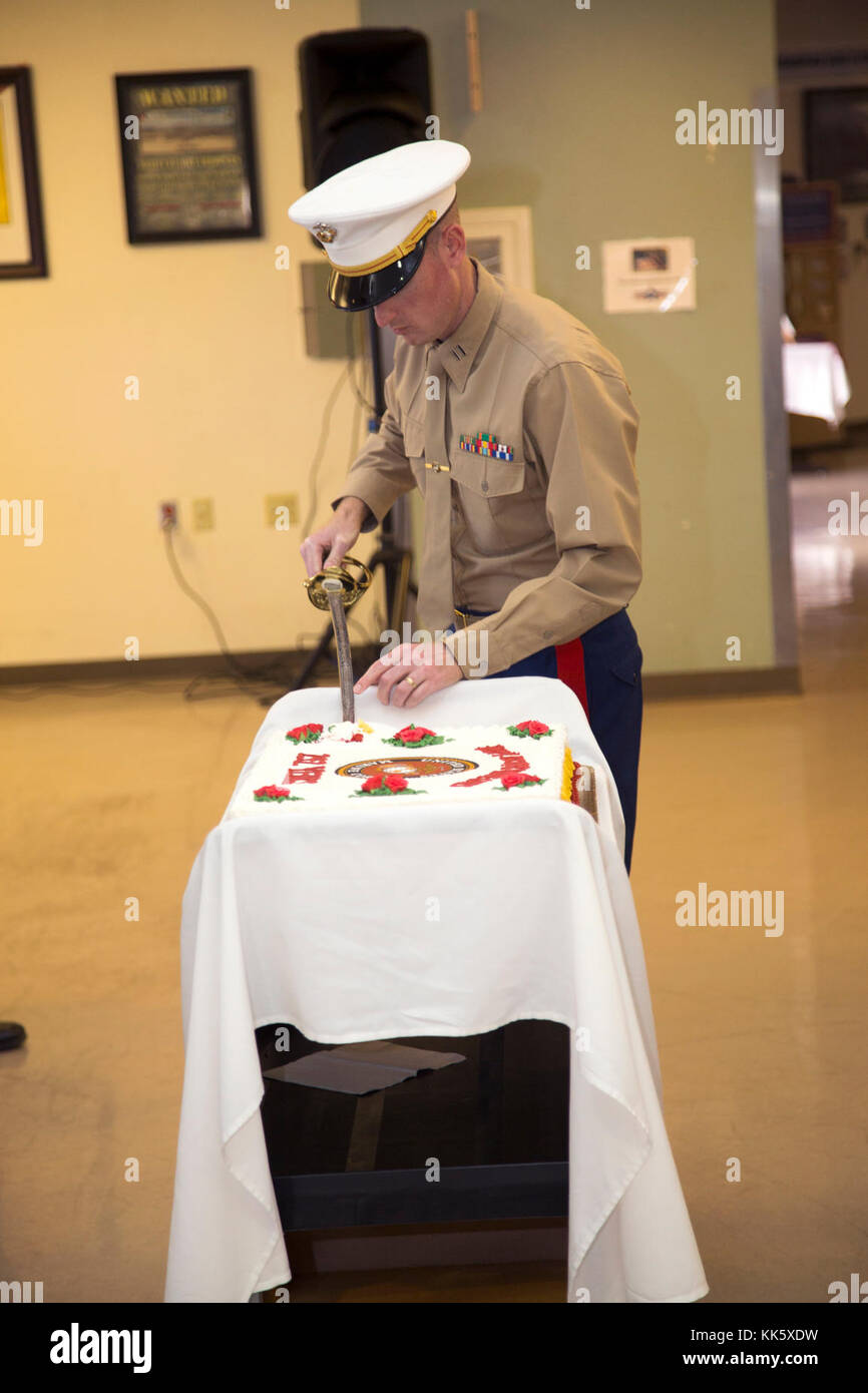 Captain Kendall Ignatz, Headquarters Company commanding officer, slices ...