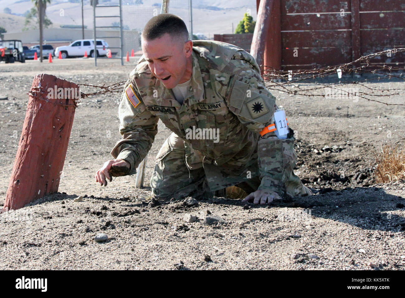Sgt. Joshua Monday emerges from a low crawl obstacle Nov. 7 during the ...