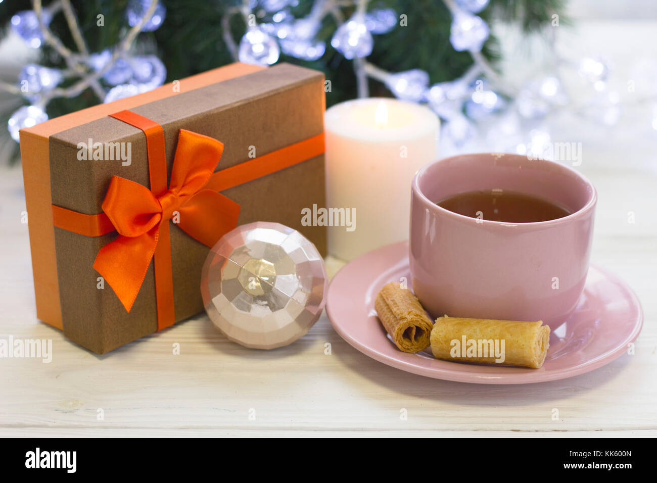 A festive still life with tea, a burning candle and a giftbox Stock ...