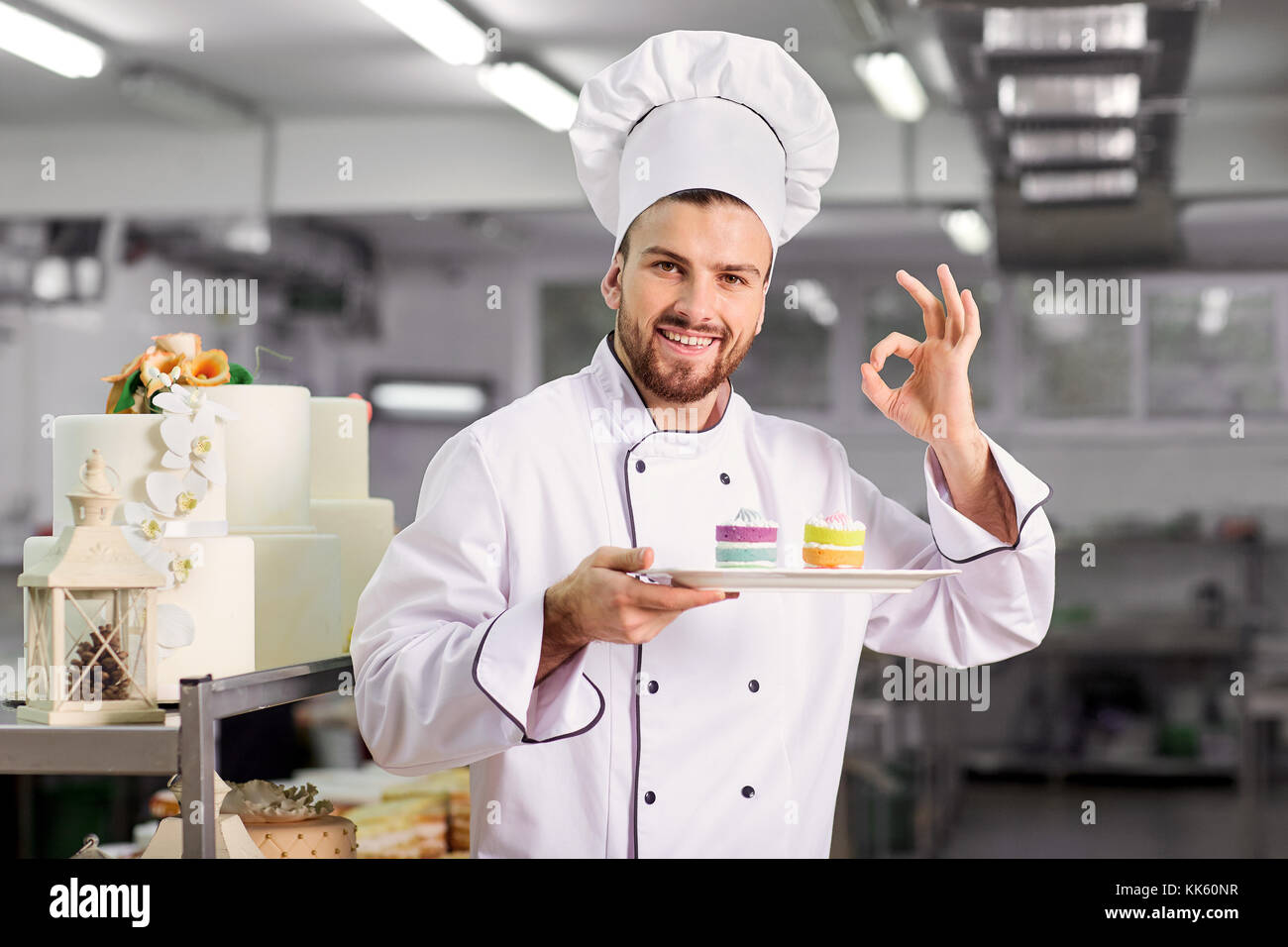 The confectioner is preparing a cake in the kitchen of the pastr Stock ...
