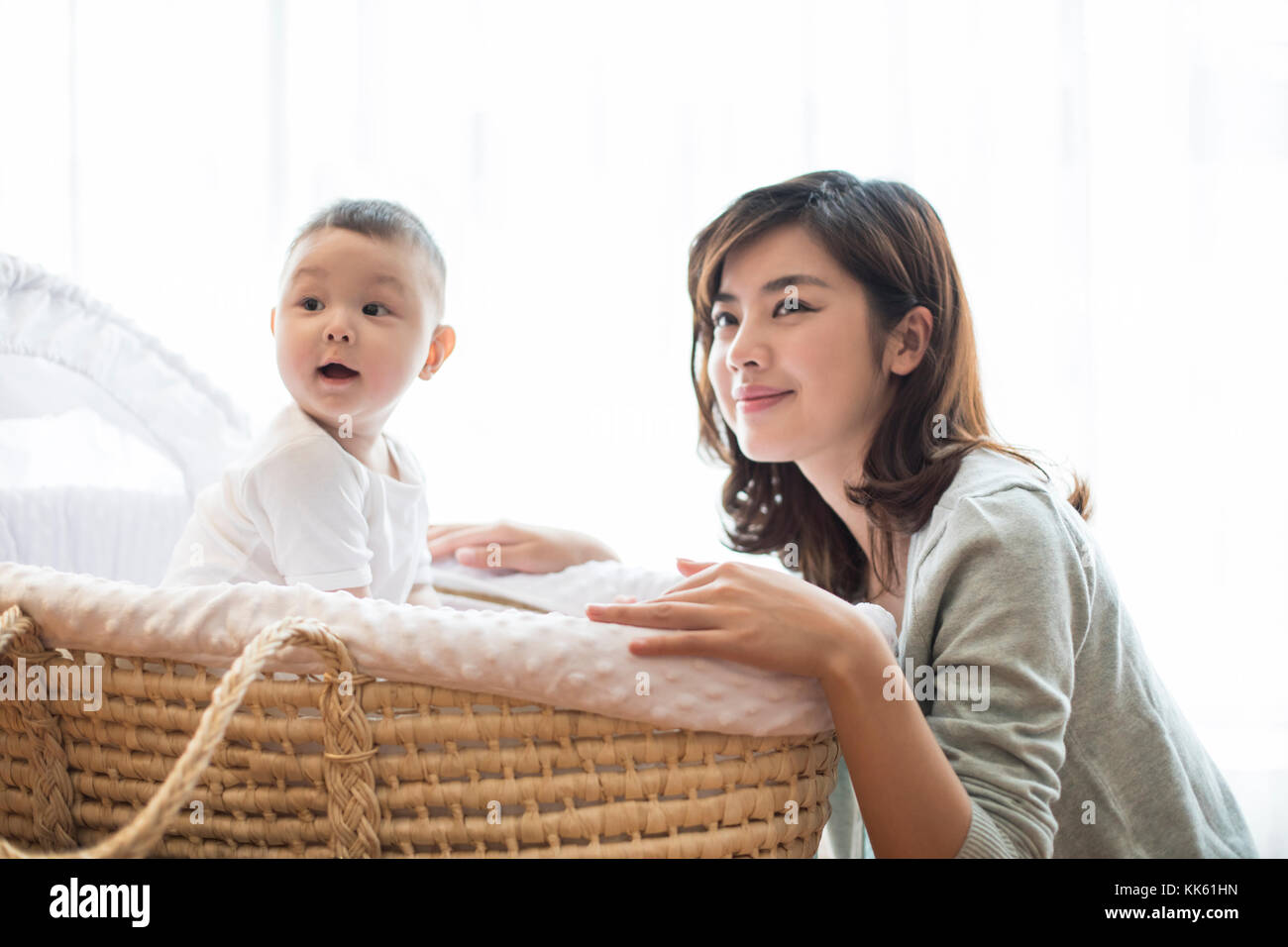 Happy Chinese mother and cute baby at home Stock Photo - Alamy