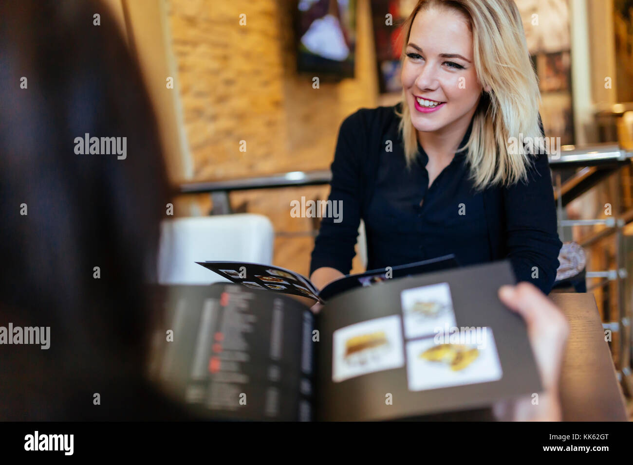 Two women looking at menu Stock Photo - Alamy
