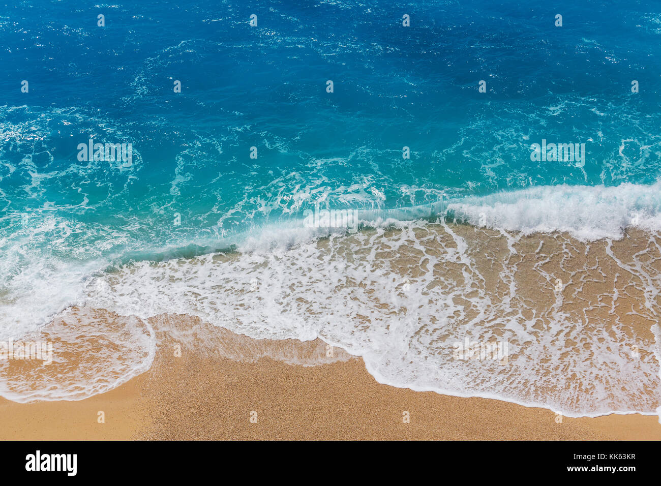 Blue wave on the beach. Blur background and sunlight spots. Peaceful ...