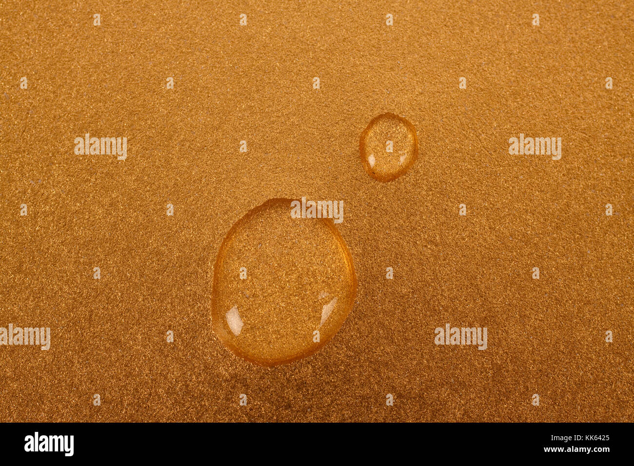 Detail of two drops on golden background Stock Photo - Alamy
