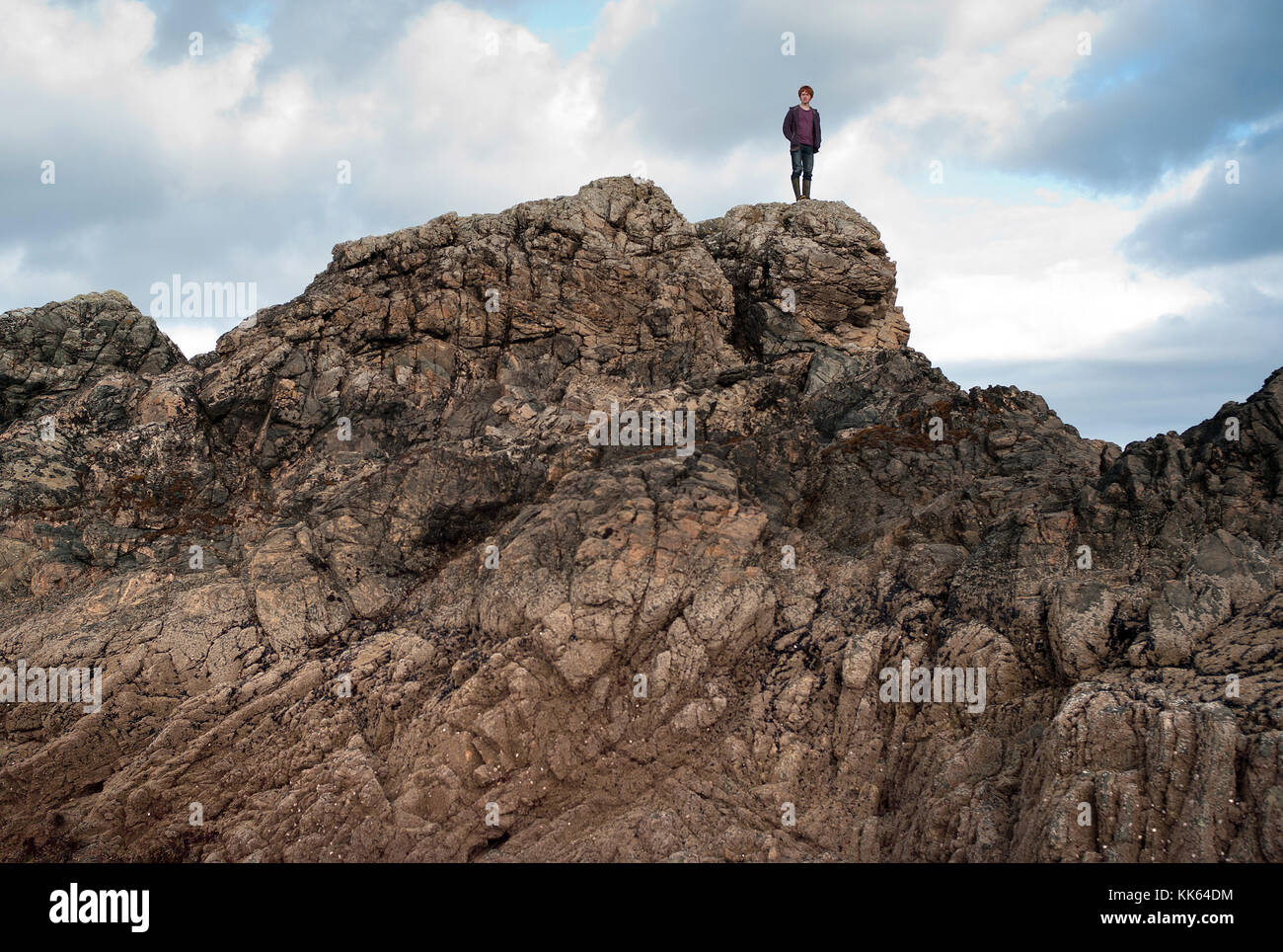 Boy standing near rocks hi-res stock photography and images - Alamy