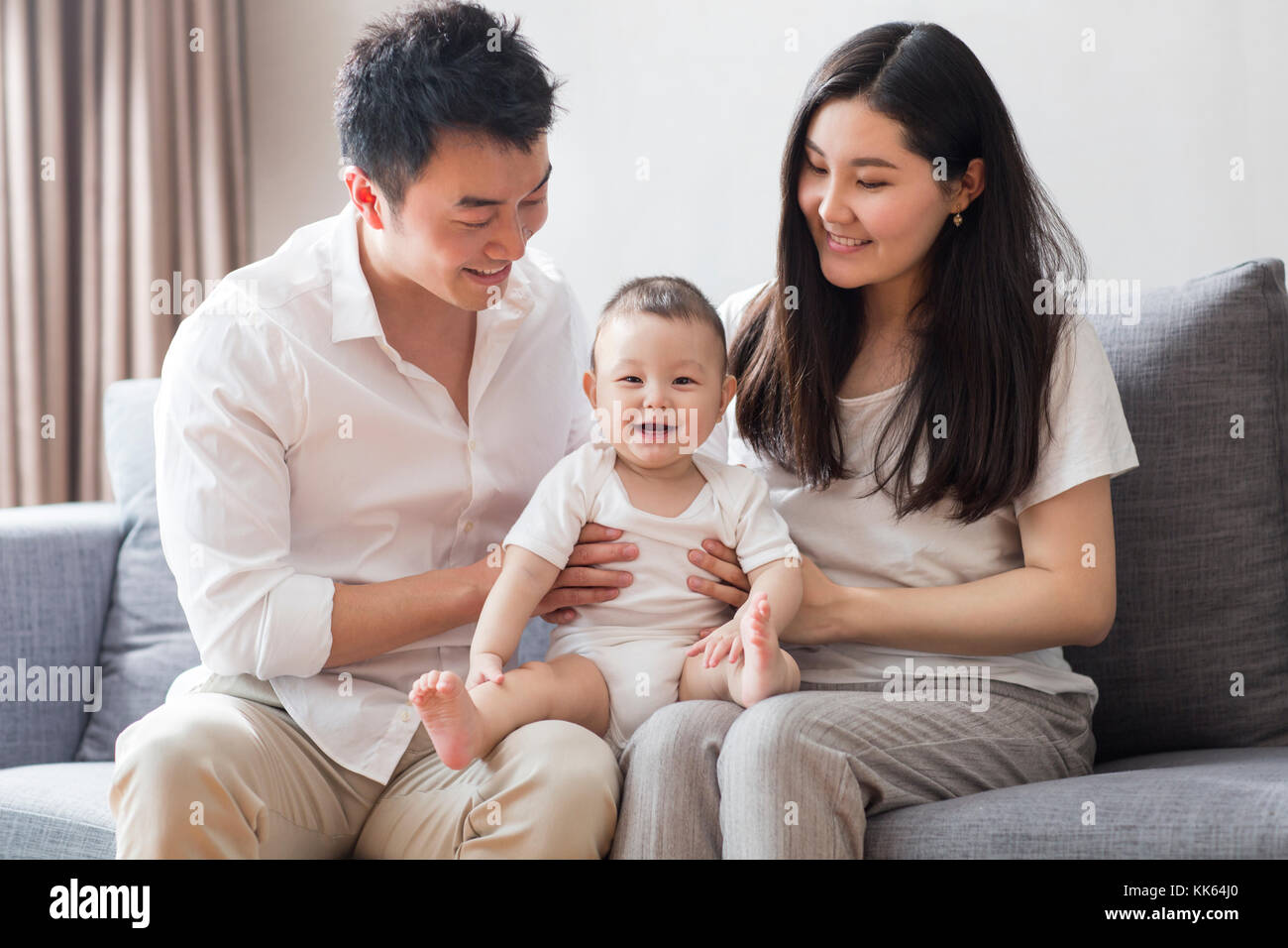 Portrait of happy young Chinese family Stock Photo - Alamy