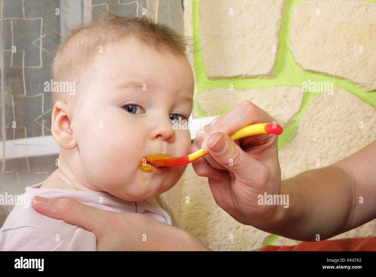 Mother and child - Baby eats puree from a spoon Stock Photo - Alamy