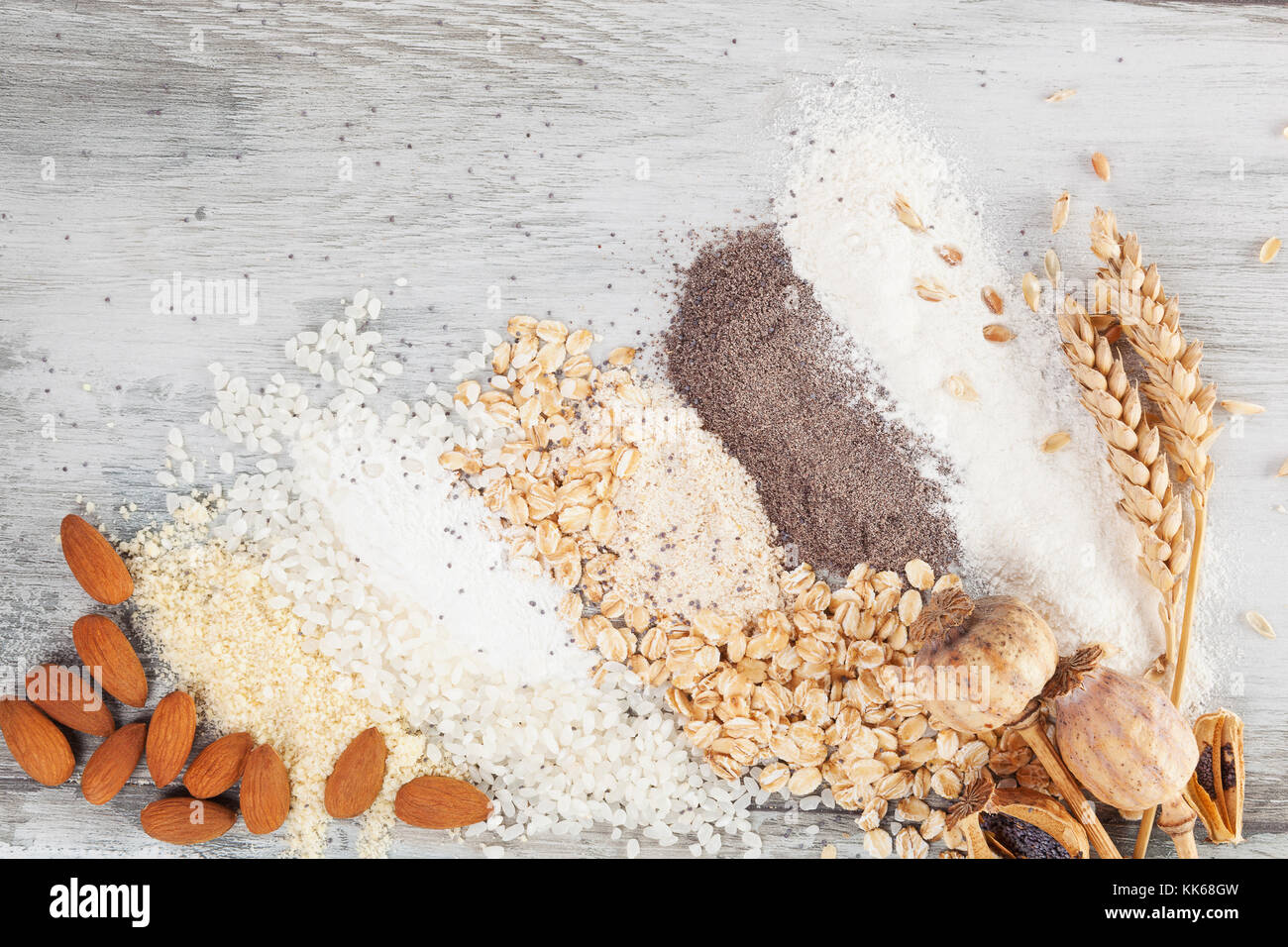 Various types of flours on wooden table from above. Rice, almonds, oat ...