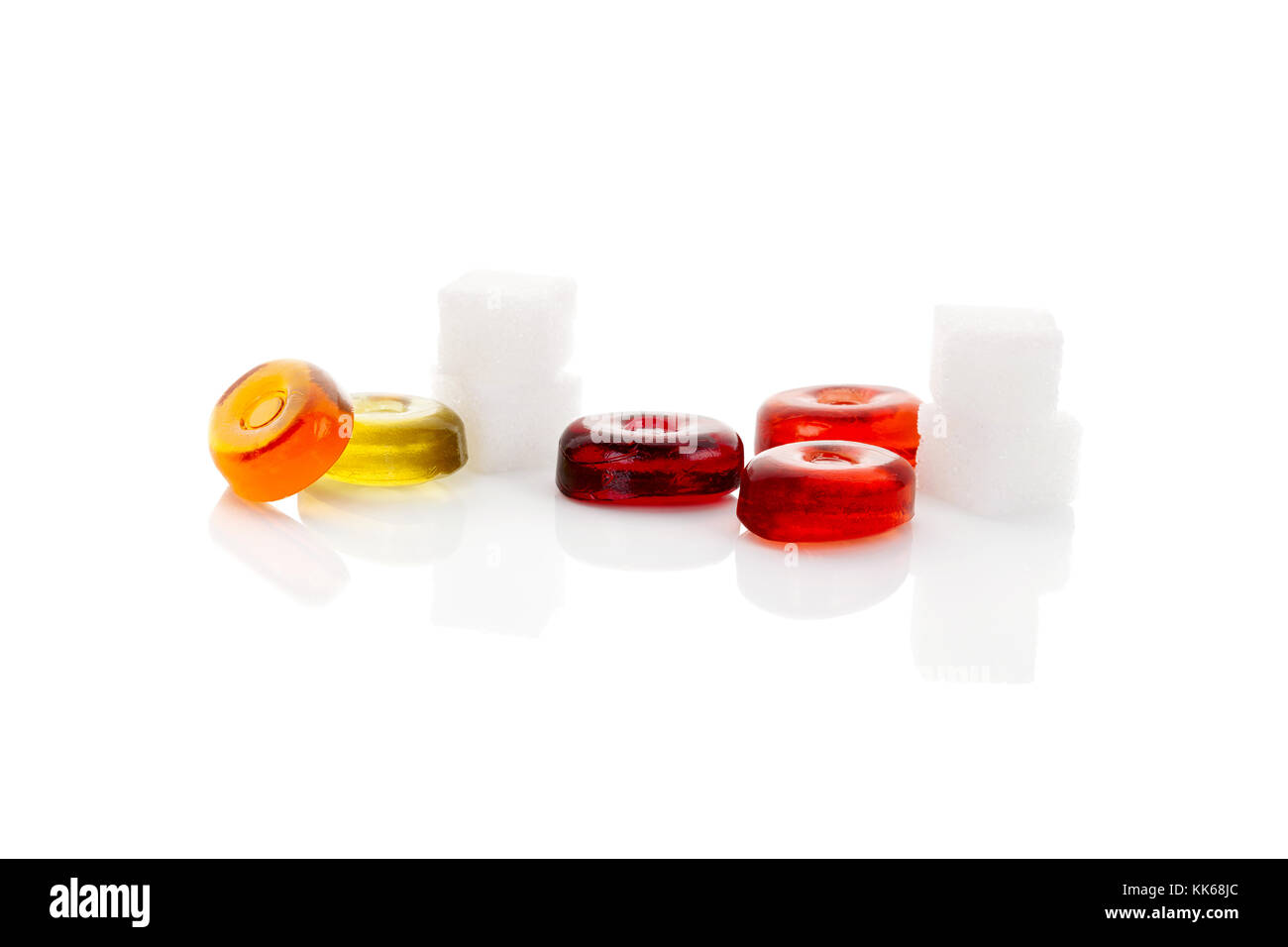 Sugar cubes with colourful hard candies. Isolated on white background ...