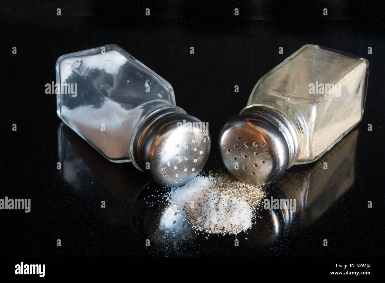 Spilled salt and pepper shakers Stock Photo - Alamy