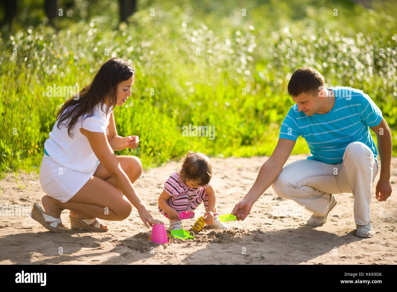 Happy Family playing with kid together summer outdoors Stock Photo - Alamy