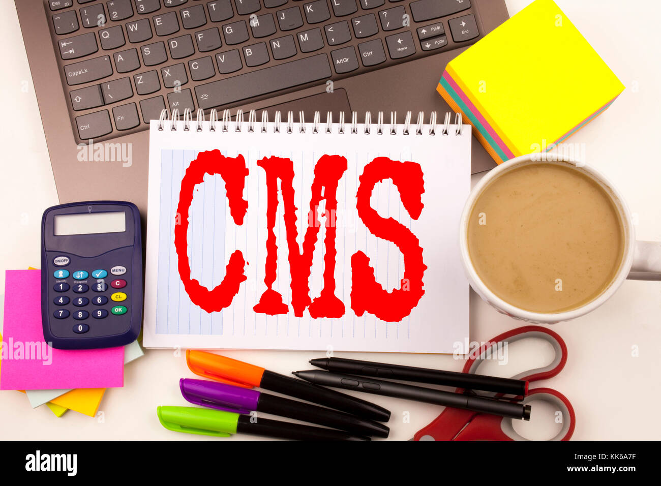 Word writing CMS in the office with laptop, marker, pen, stationery ...