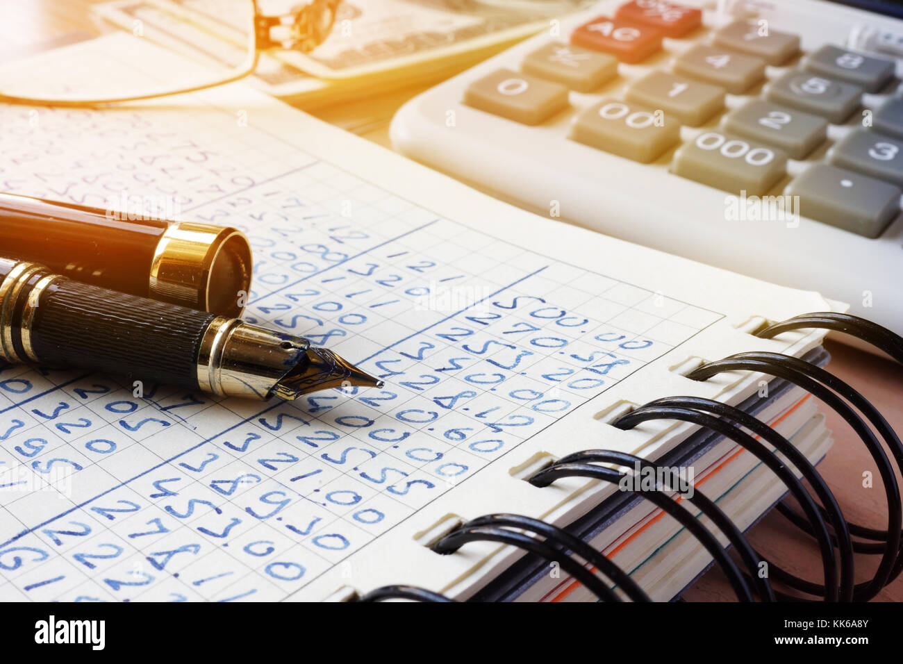 Business data in an accounting book and calculator Stock Photo - Alamy