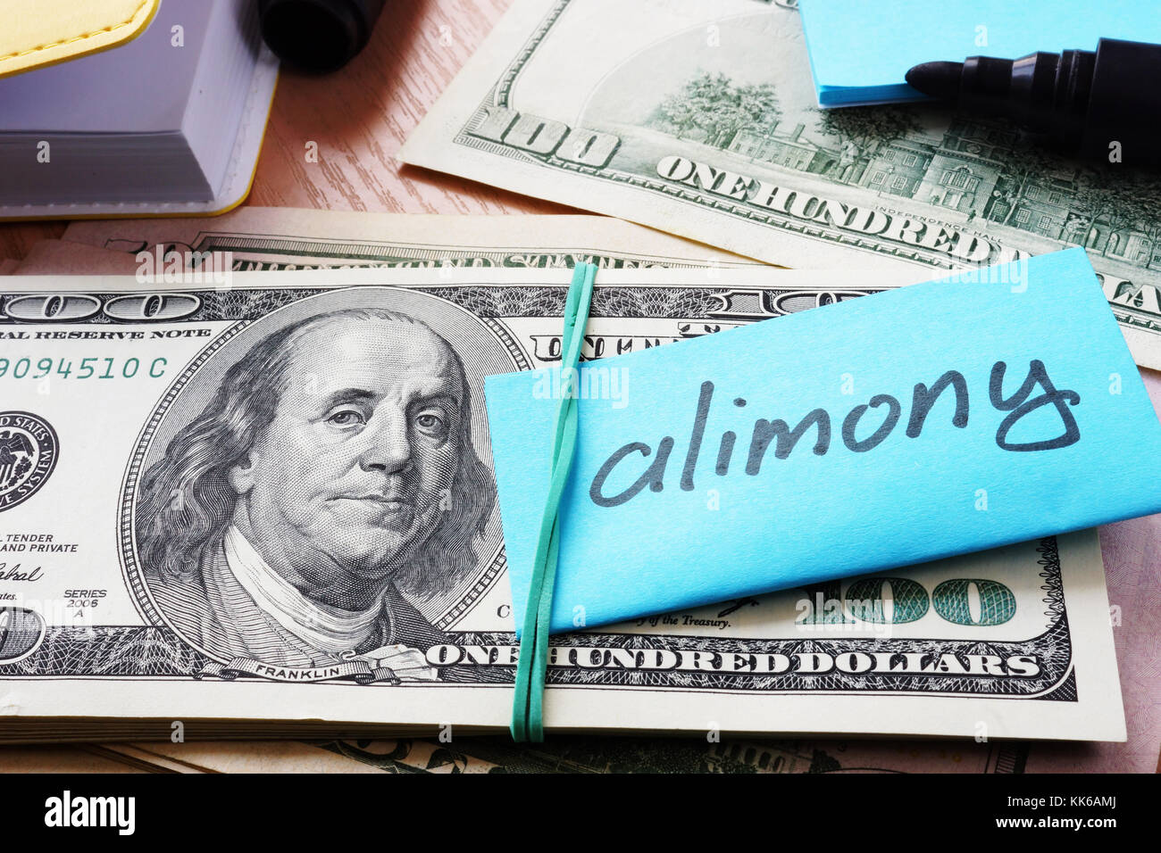 Pile of dollars with word alimony on a stick Stock Photo - Alamy