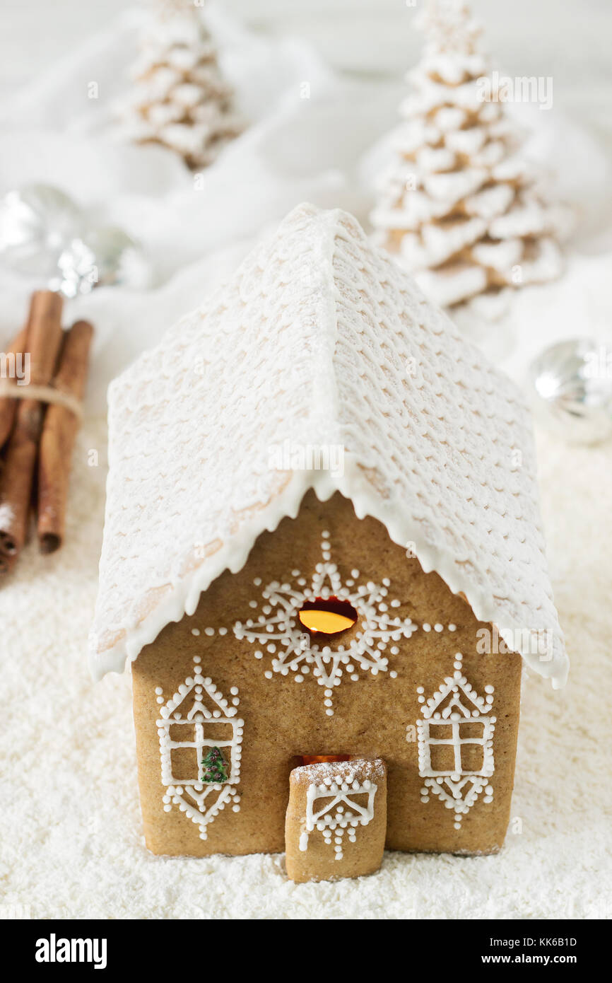 Gingerbread house and gingerbread tree on a light background. Selective ...
