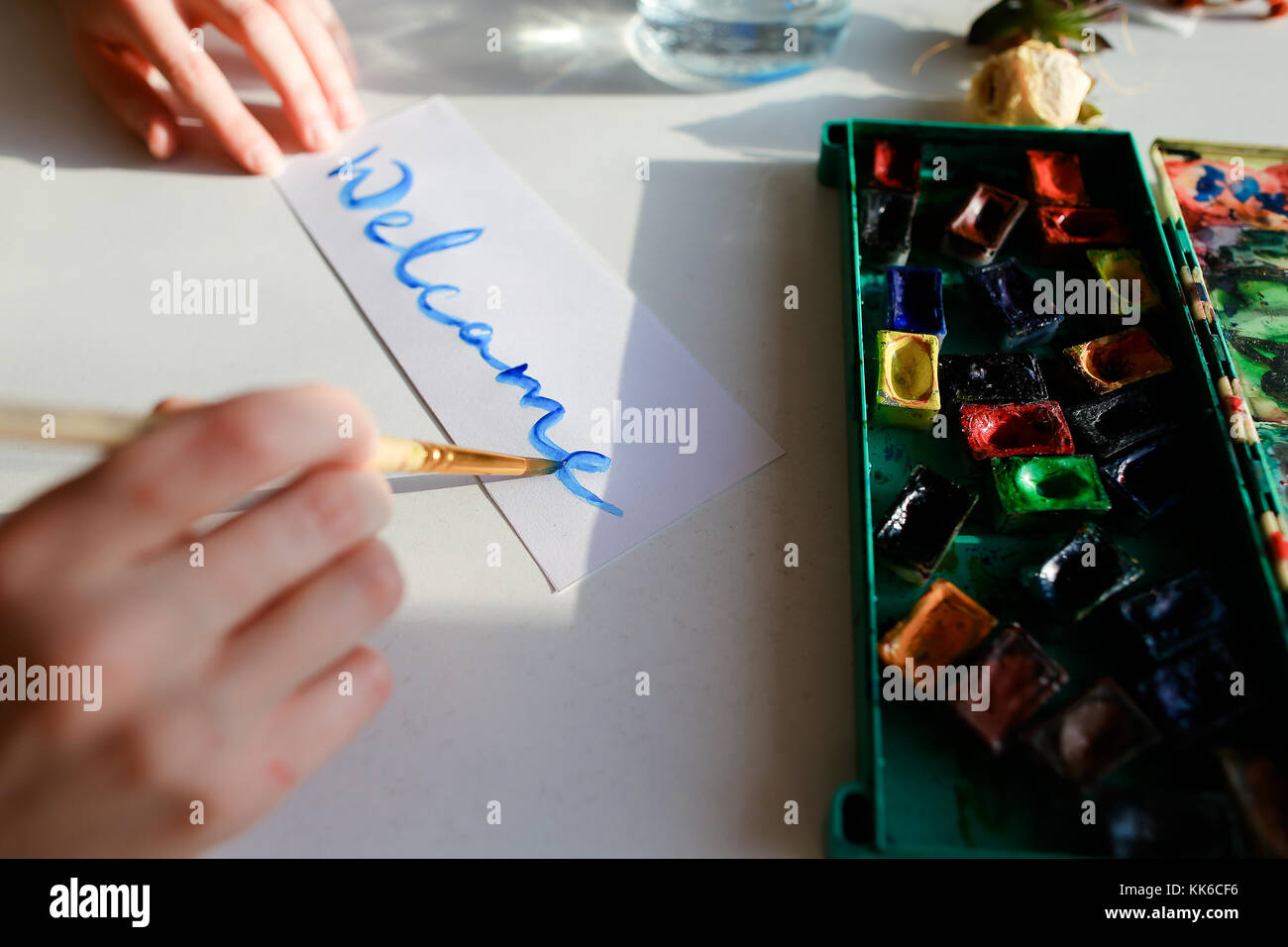 Young woman painter writes watercolor writing on paper, sitting Stock ...