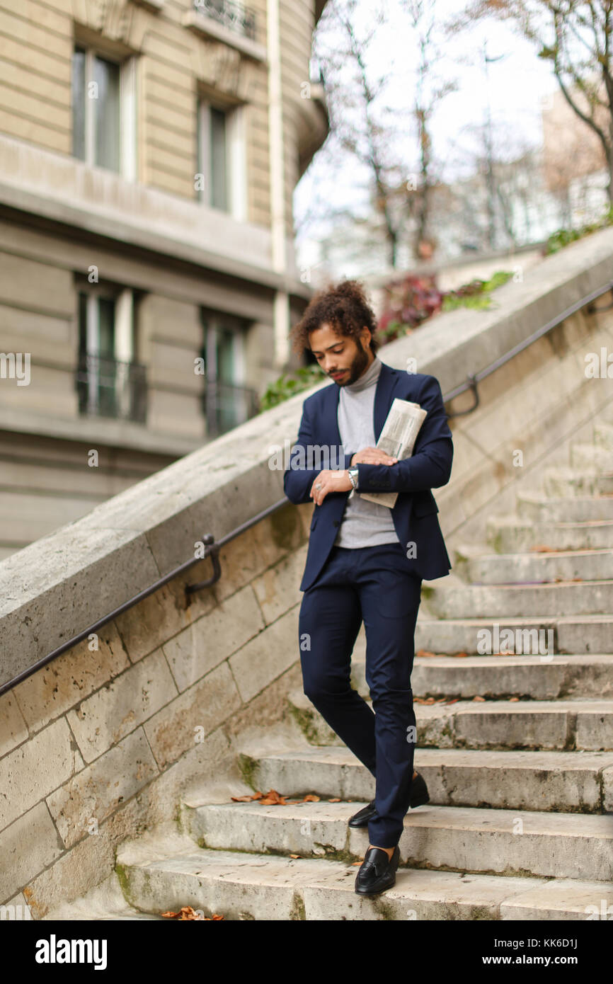 Handsome mix blood man walking down steps with newspaper Stock Photo ...