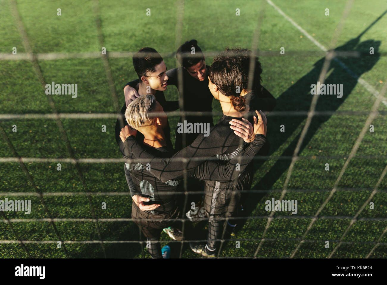 Young sports team standing in circle. Five a side football team ...