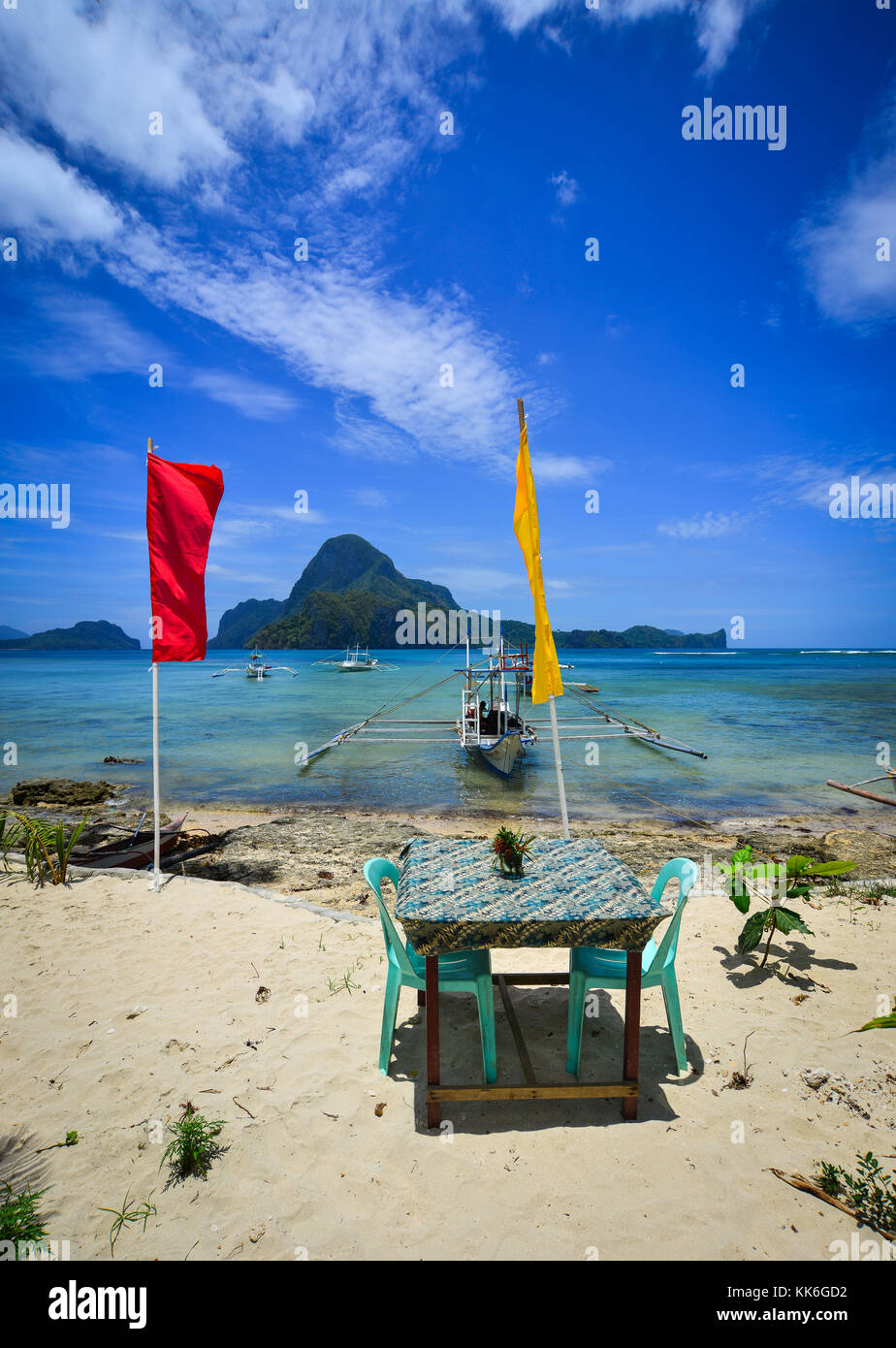A table of outdoor restaurant on beach in Coron Island, Philippines ...