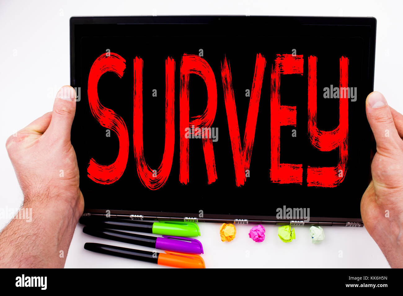 Survey text written on tablet, computer in the office with marker, pen ...