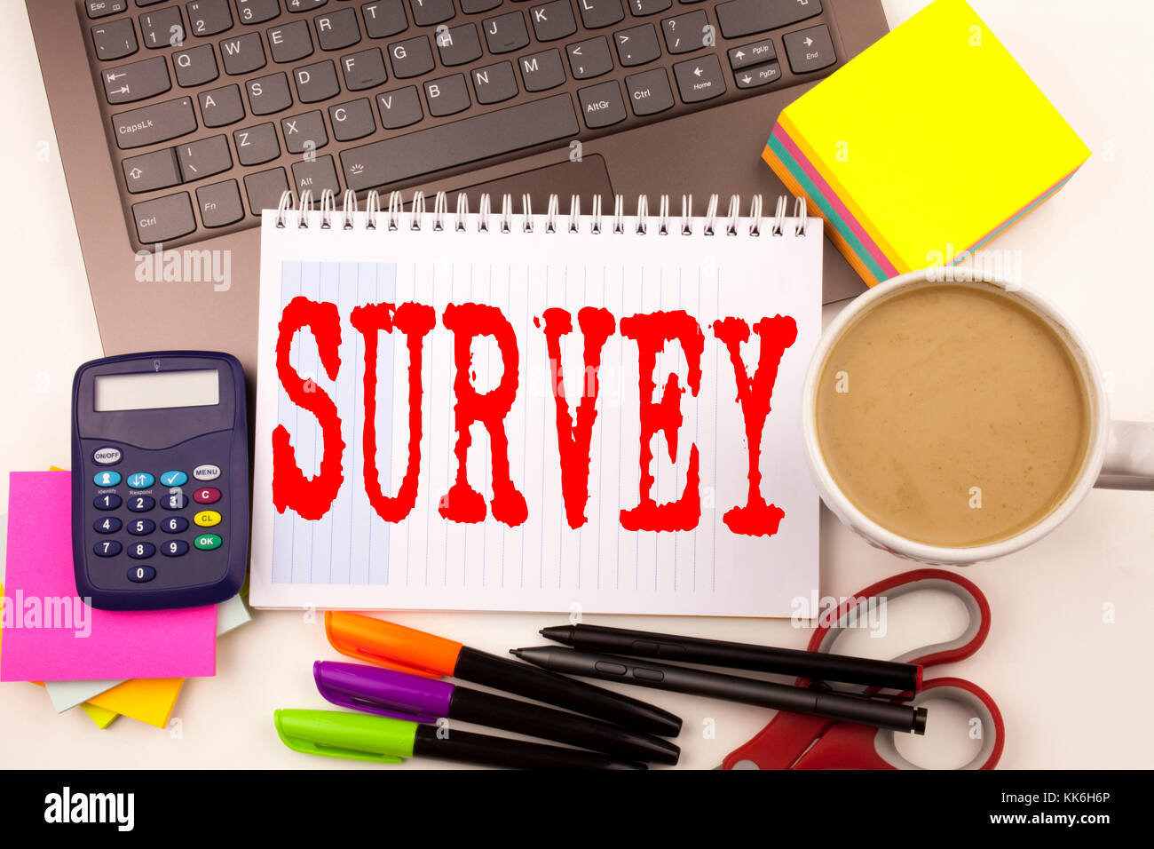 Word writing Survey in the office with laptop, marker, pen, stationery ...