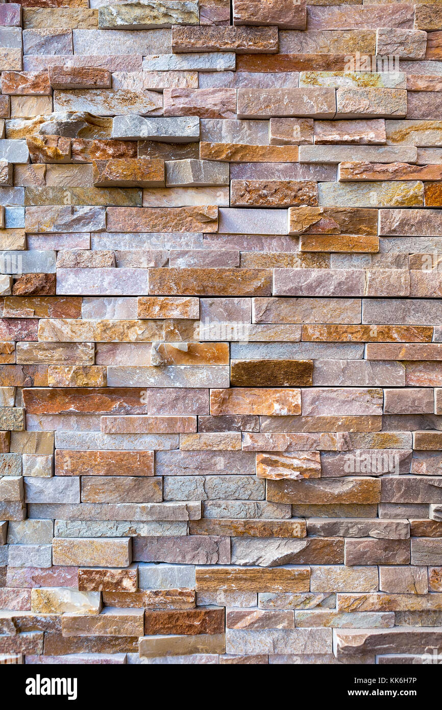 Stacked stone rock wall on building exterior background Stock Photo - Alamy